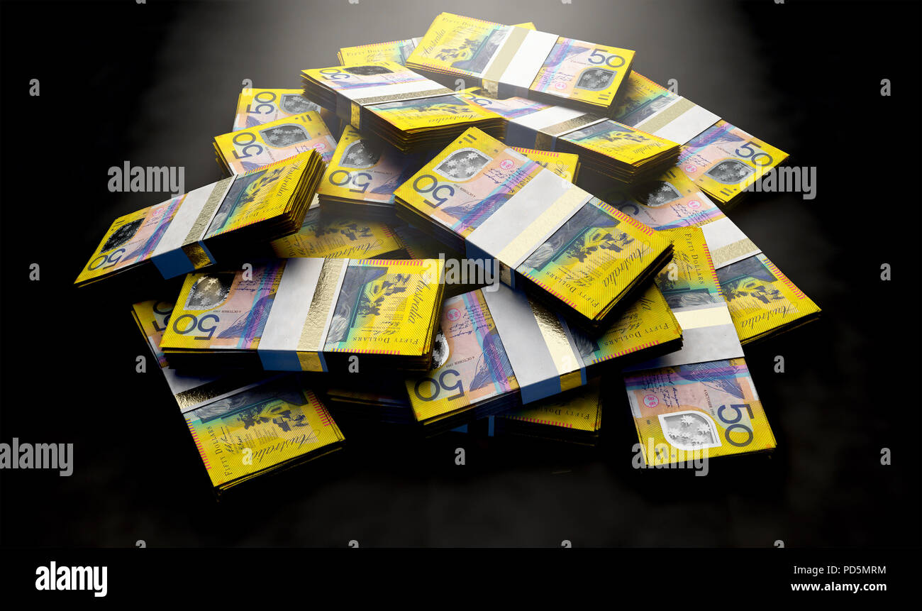 A pile of randomly scattered bundles of Australian dollar banknotes on ...