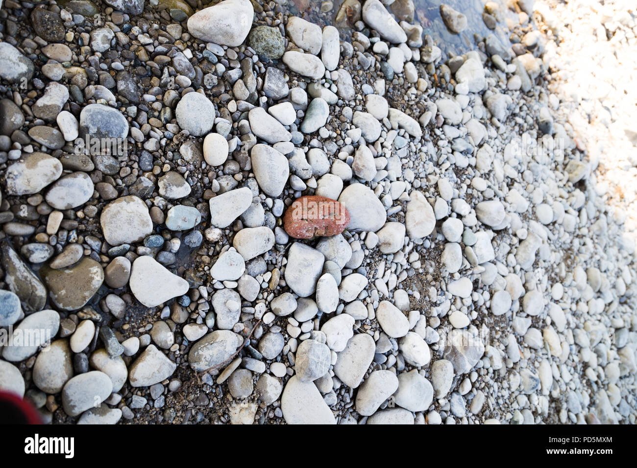 a red stone at the river Stock Photo - Alamy