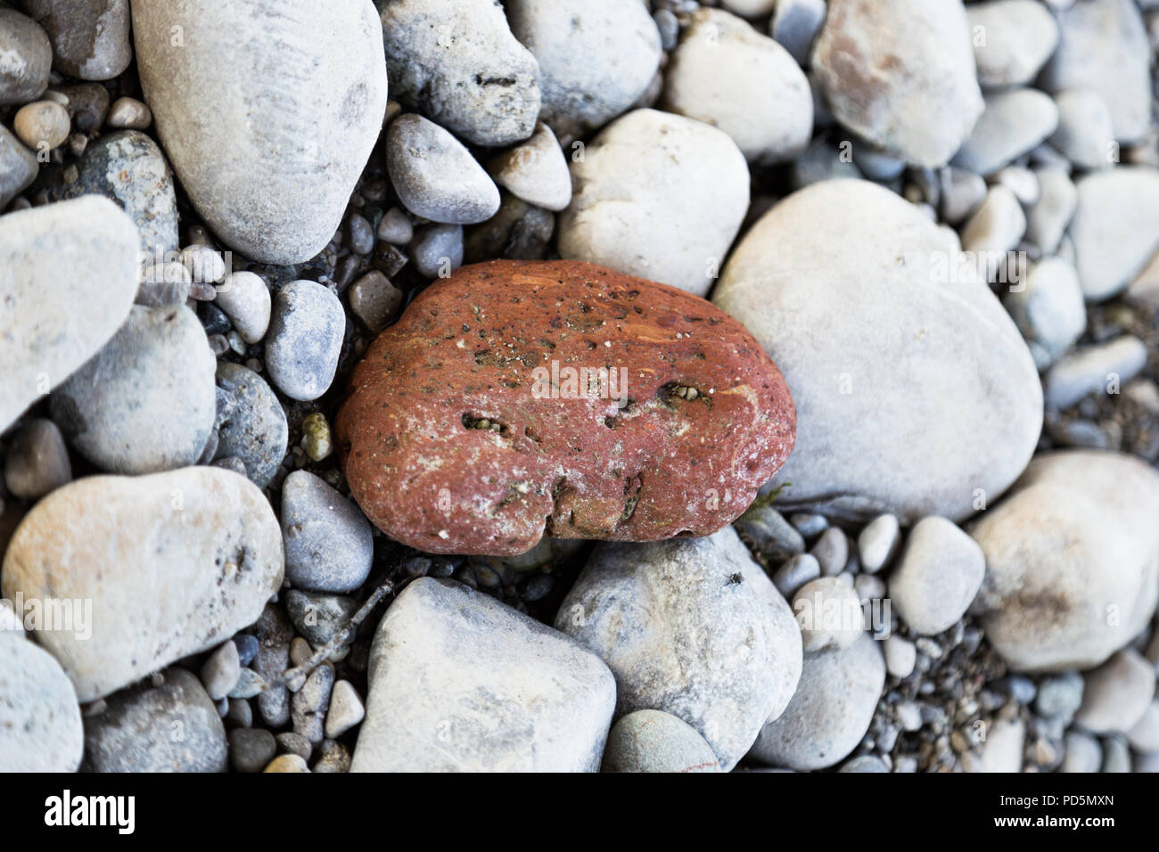 a red stone at the river Stock Photo - Alamy
