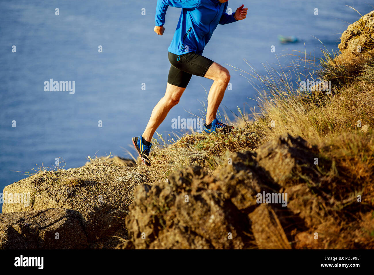 running on steep slope of mountain male athlete runner Stock Photo - Alamy