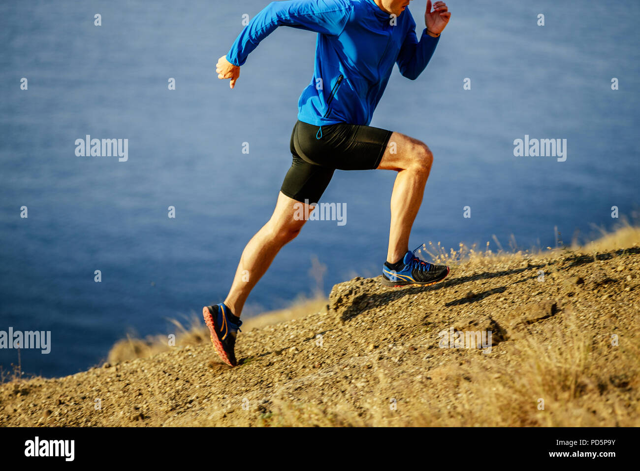 man runner dynamic running on steep slope of mountain Stock Photo - Alamy