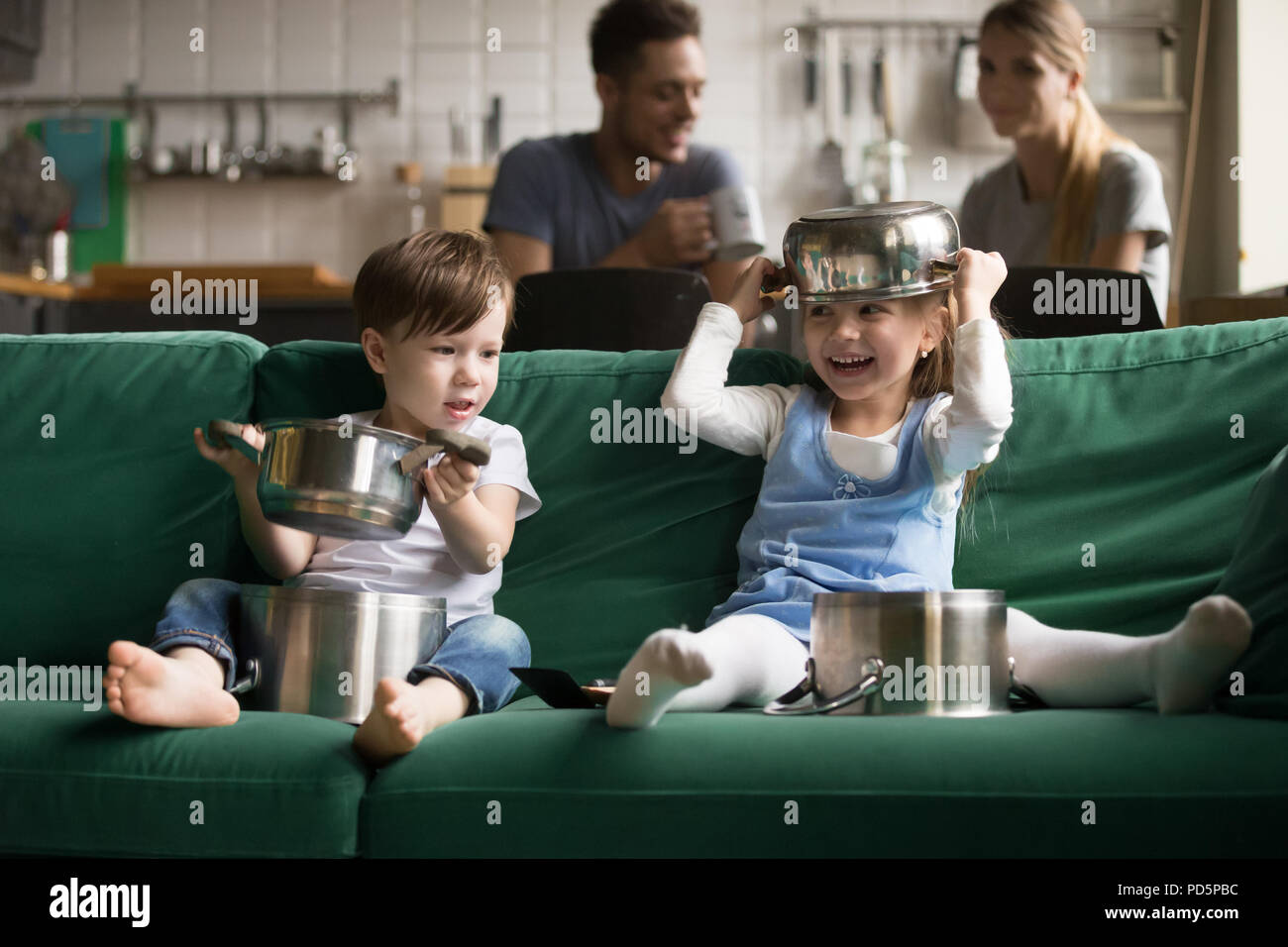 Happy funny kids playing with kitchenware cooking pots at home Stock ...