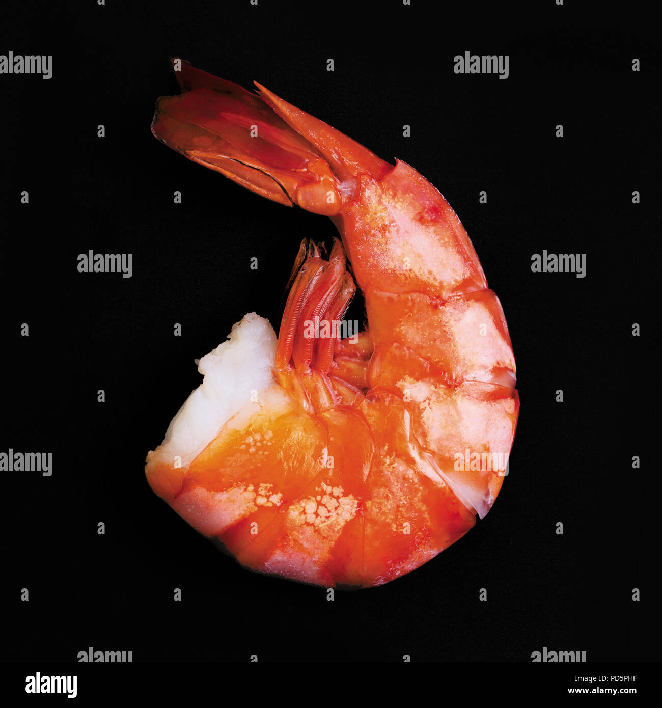 Boiled shrimp without head on a black background Stock Photo - Alamy