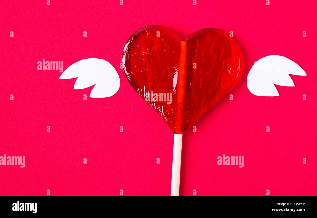 One candy heart shape on pink background Stock Photo - Alamy