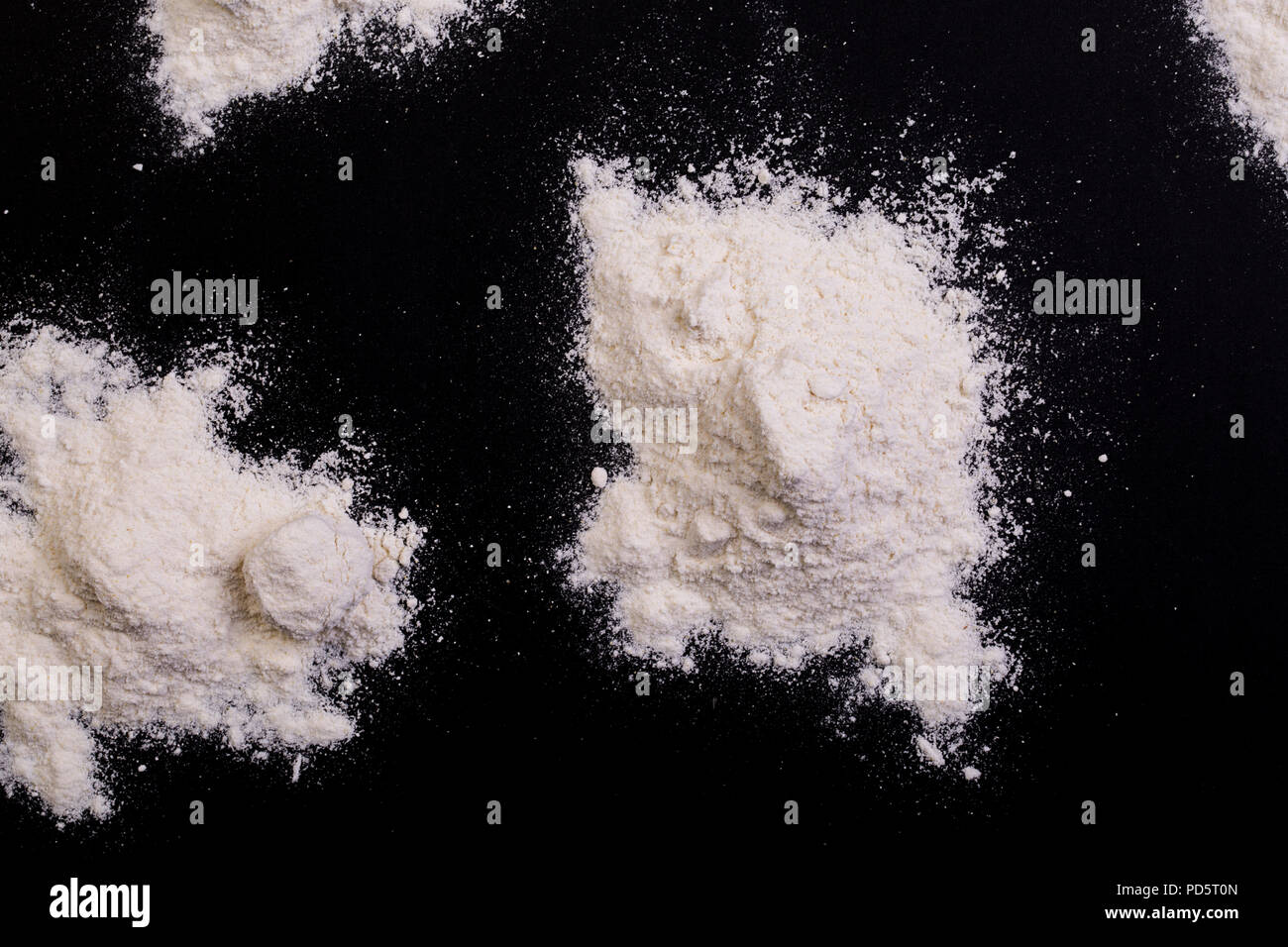 wheat flour pile on black background Stock Photo - Alamy