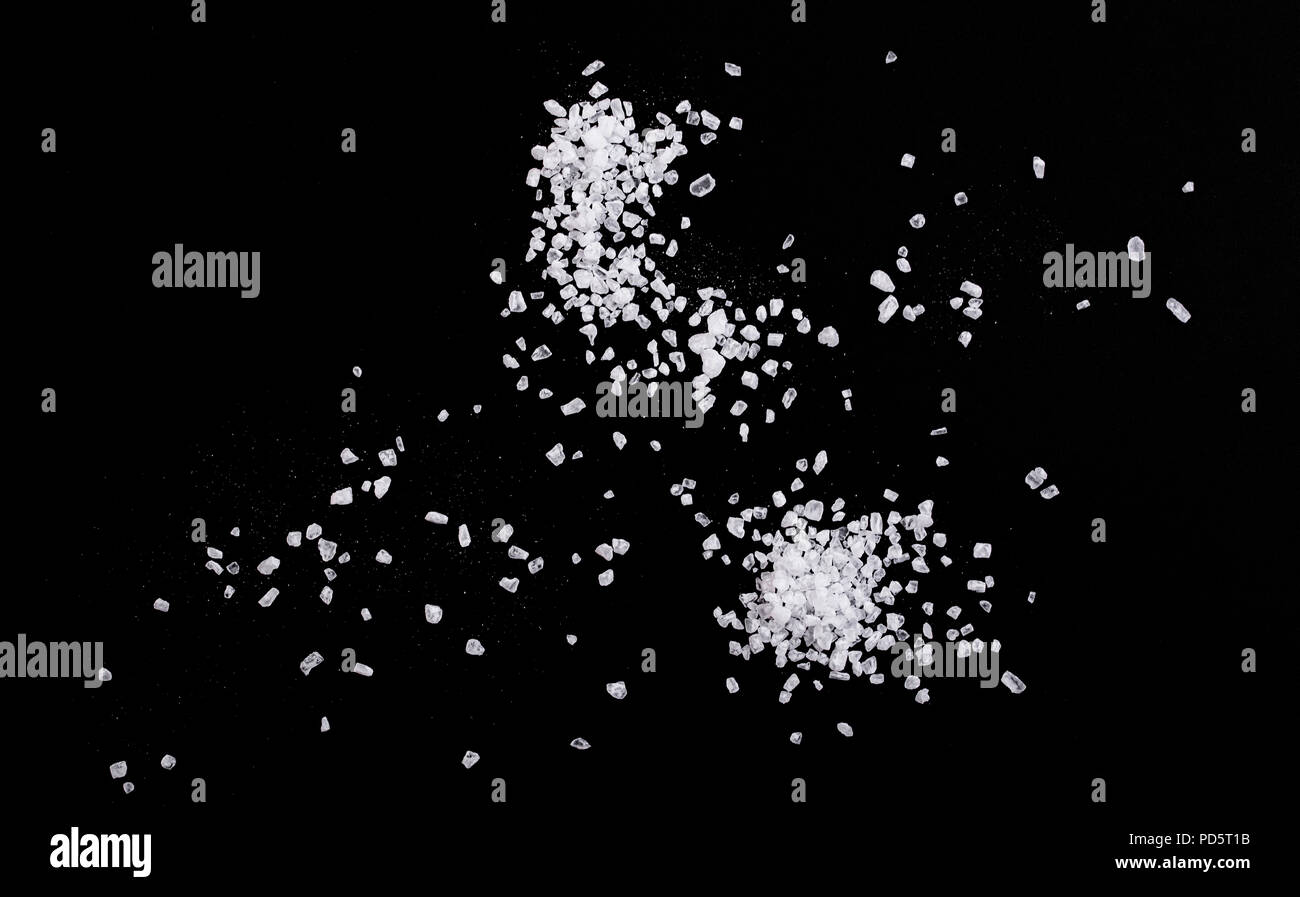 A handful of sea salt on a black background Stock Photo - Alamy