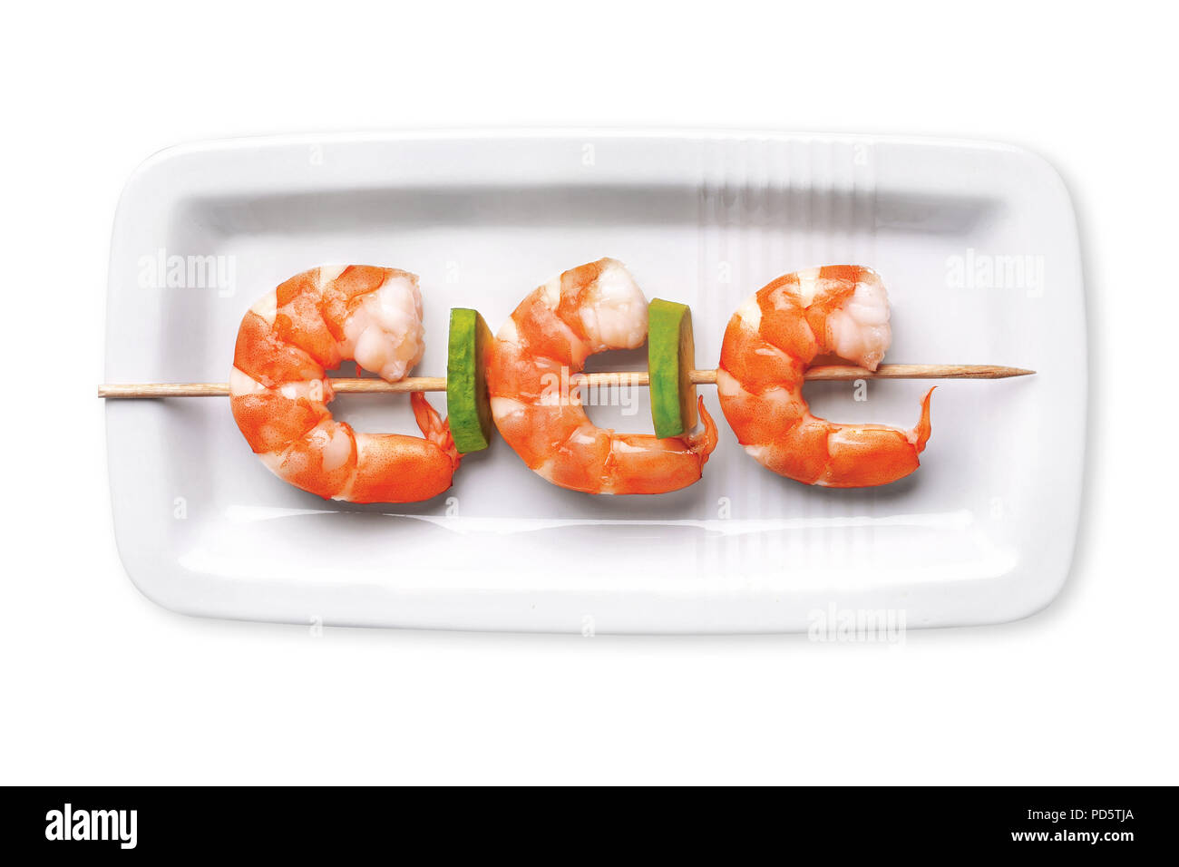 Three prawns and avocado on a wooden skewer in white plate isolated on ...