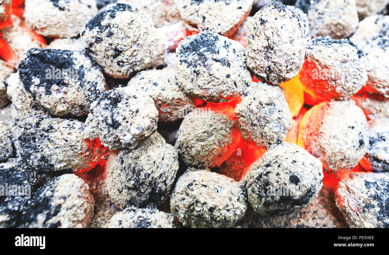 Burned BBQ coals in outdoor camping area. Colorful background of burnt ...