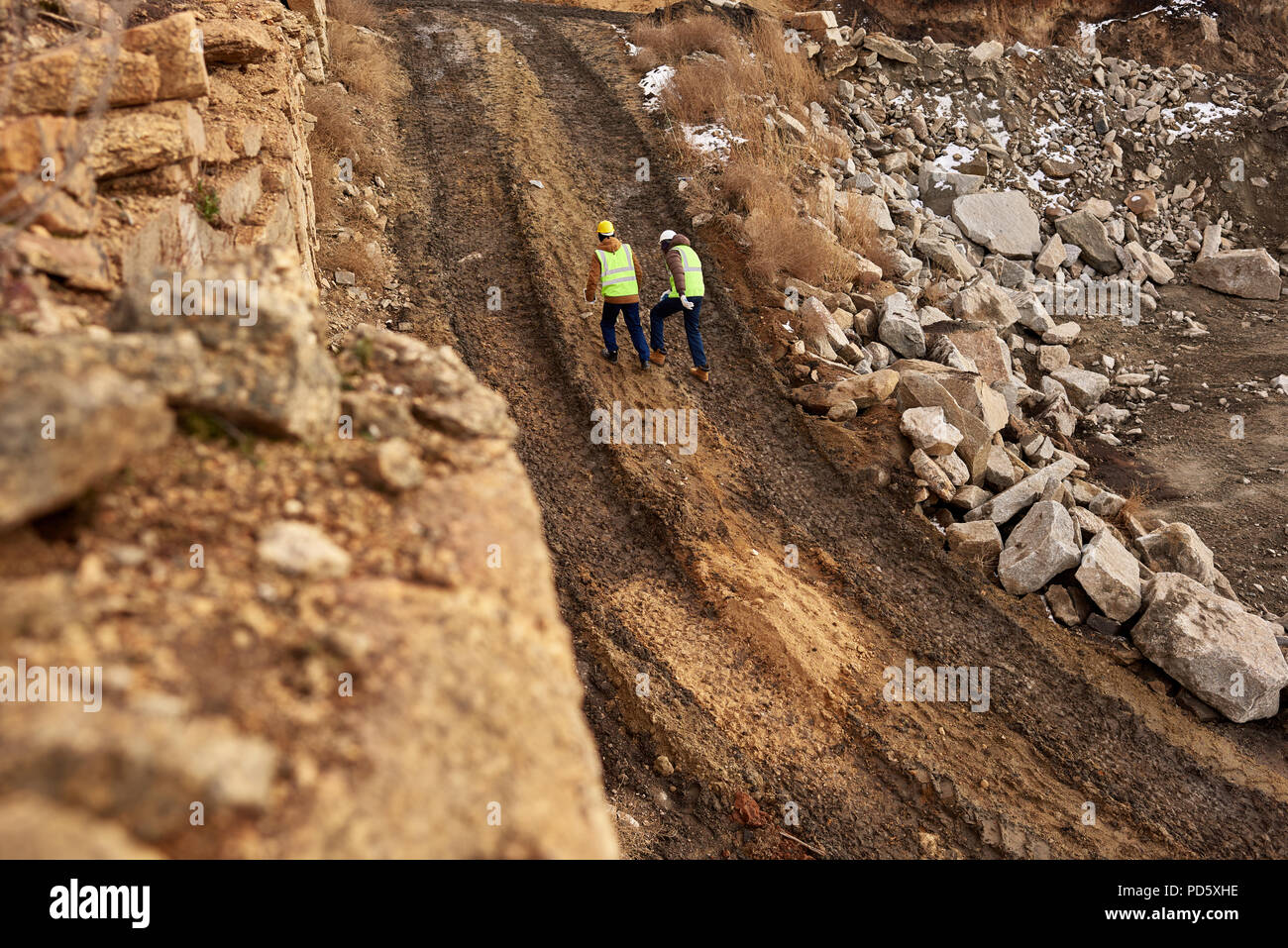 Wide angle shot of two industrial workers wearing reflective jackets ...