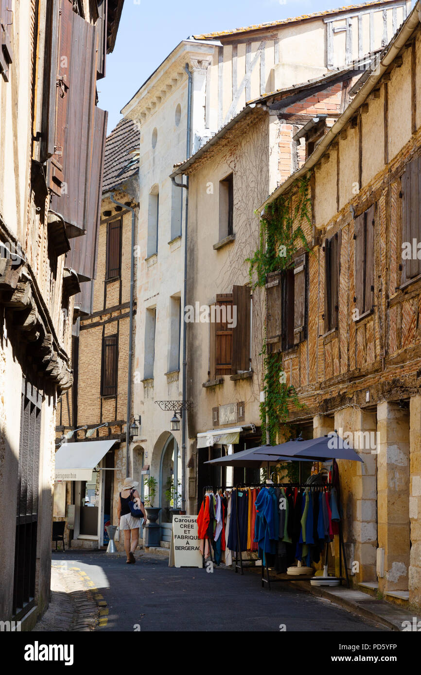 A woman tourist walking in the narrow streets of Bergerac old town ...