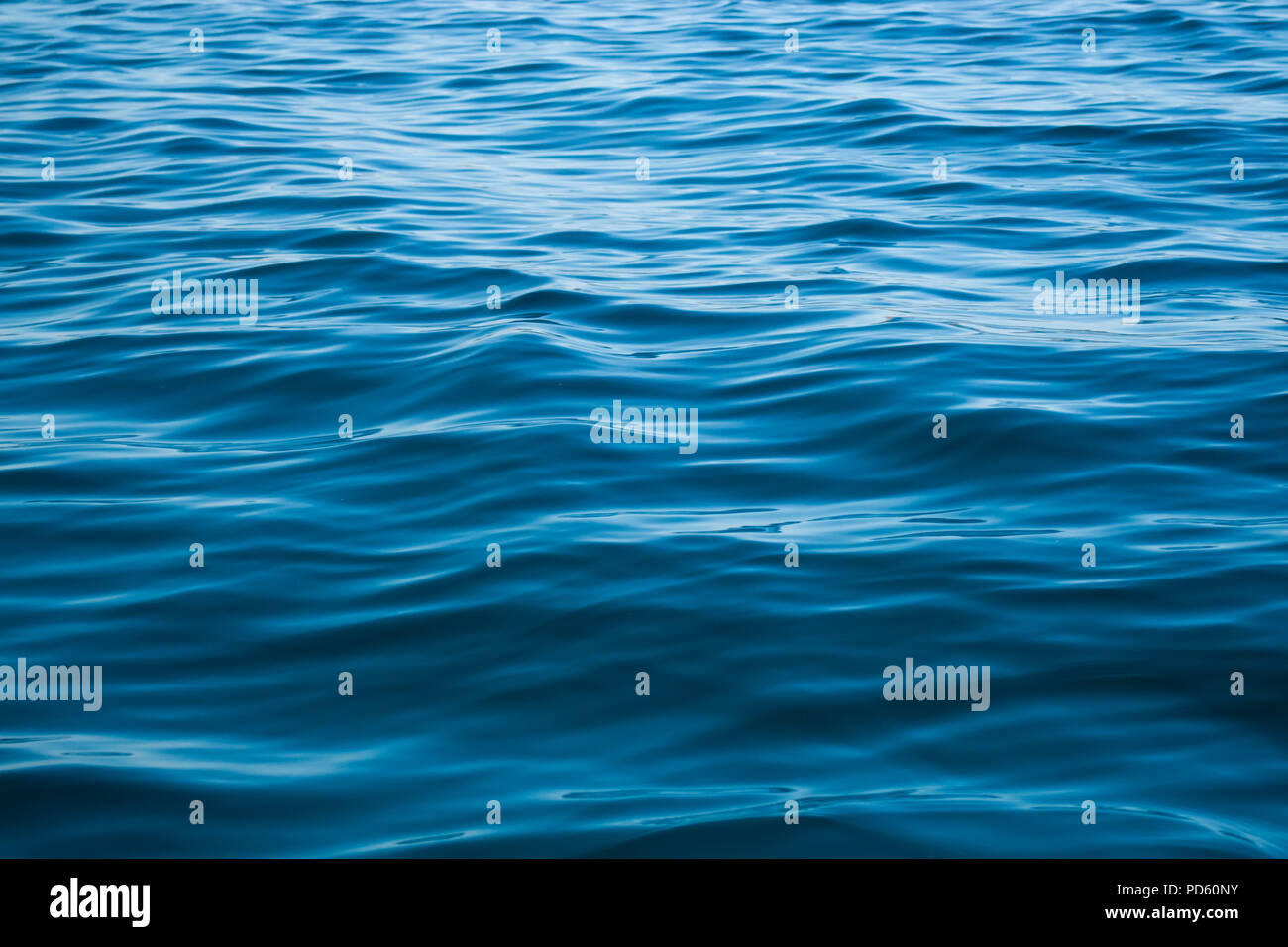 Deep blue water texture with some big and small waves Stock Photo - Alamy