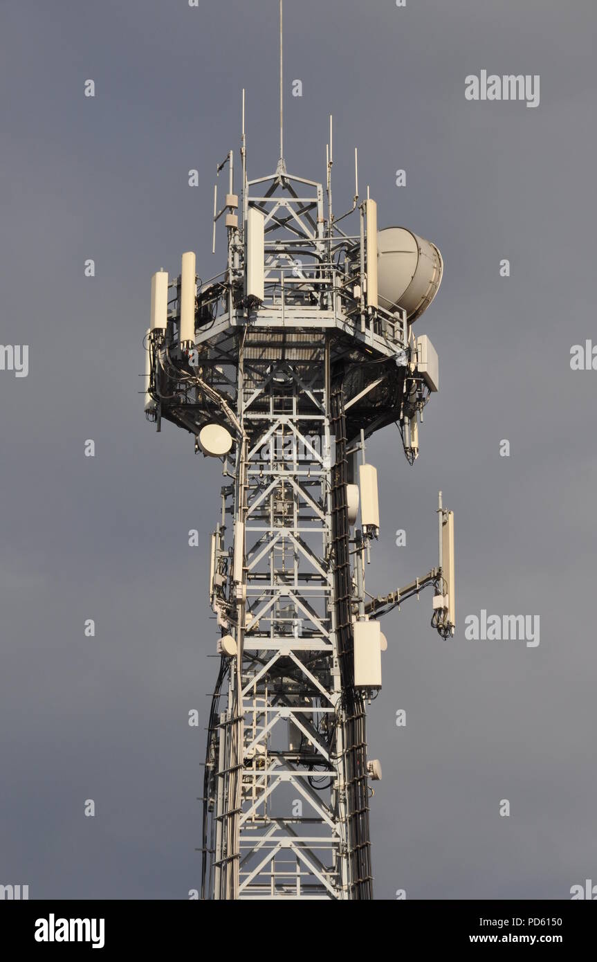 Communication cell tower against cloudy sky Stock Photo - Alamy