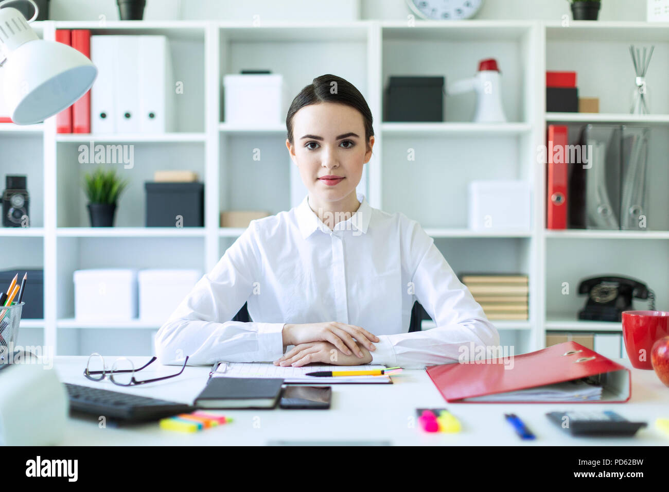 A young girl is sitting at the computer desk in the office Stock Photo ...