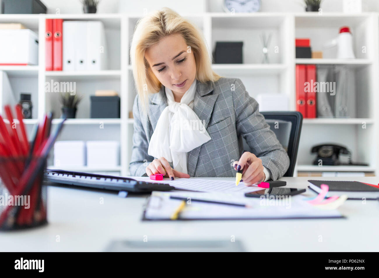 Young girl in the office working with a marker and documents Stock ...