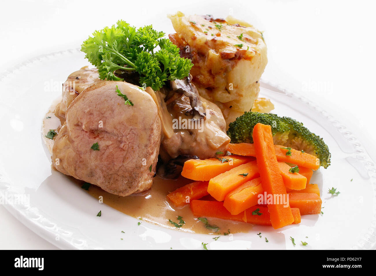 plated pork dinner meal Stock Photo - Alamy