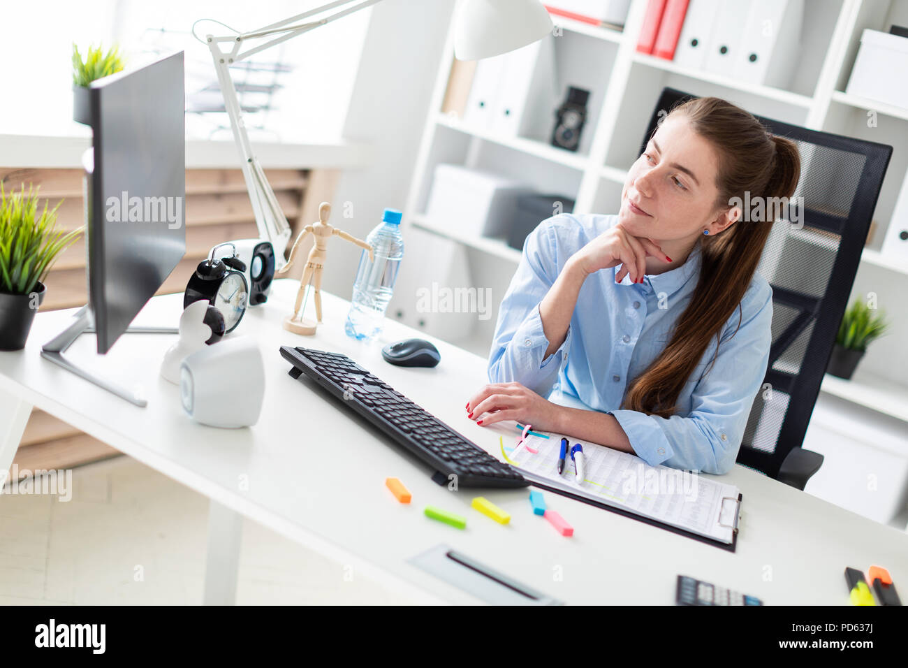 Young girl in the office sits at the computer desk Stock Photo - Alamy
