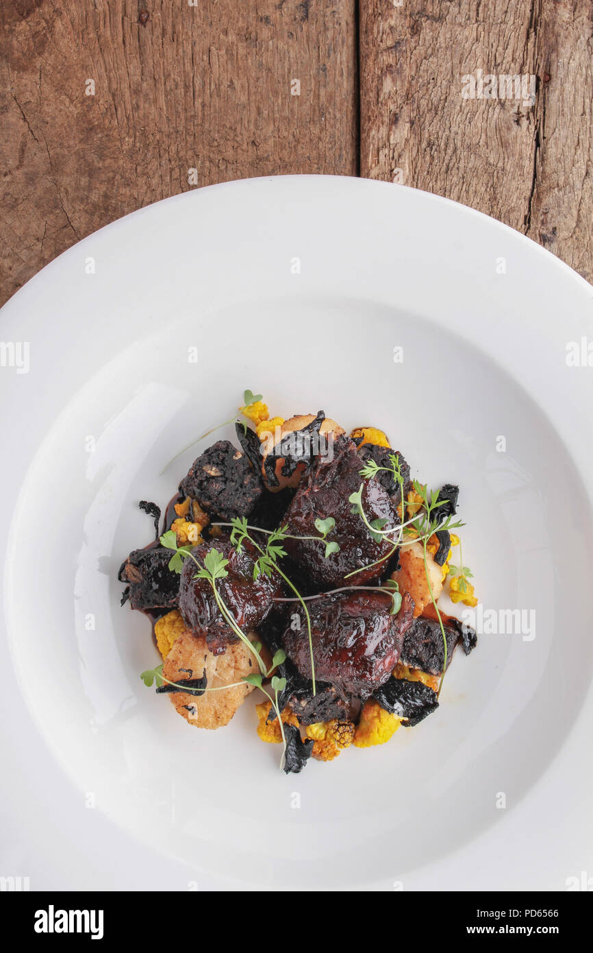 pigs cheek scallop black pudding starter Stock Photo - Alamy