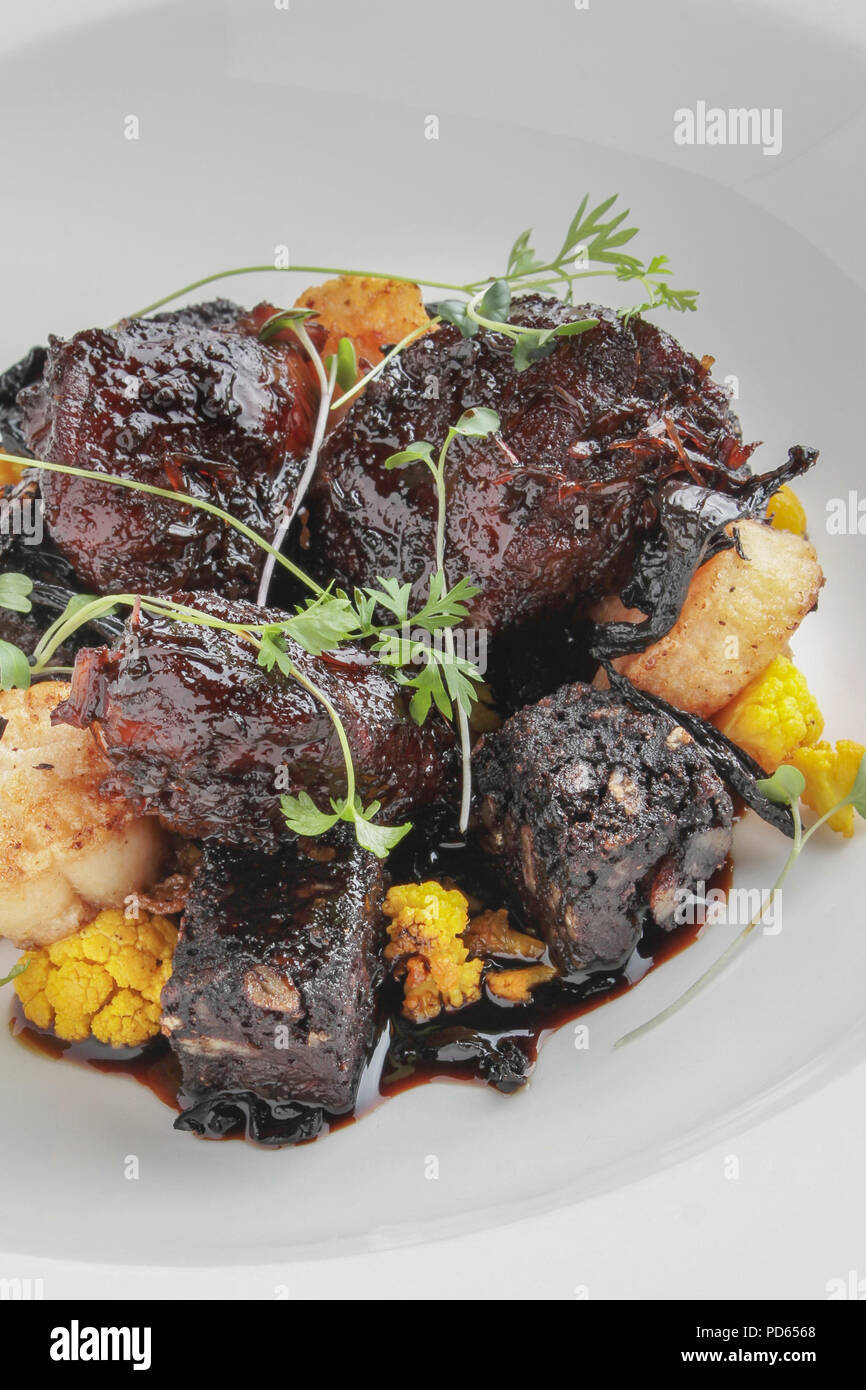 pigs cheek scallop black pudding starter Stock Photo - Alamy