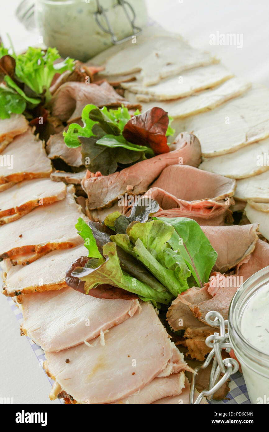 fresh sliced cold meat selection buffet table Stock Photo - Alamy