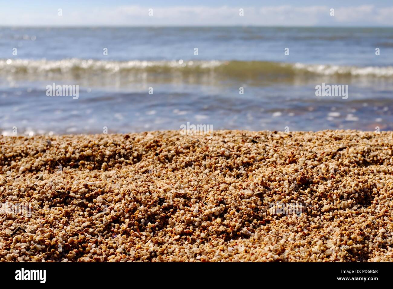 Australian gravel and shell coarse beach sand with waves in the ...