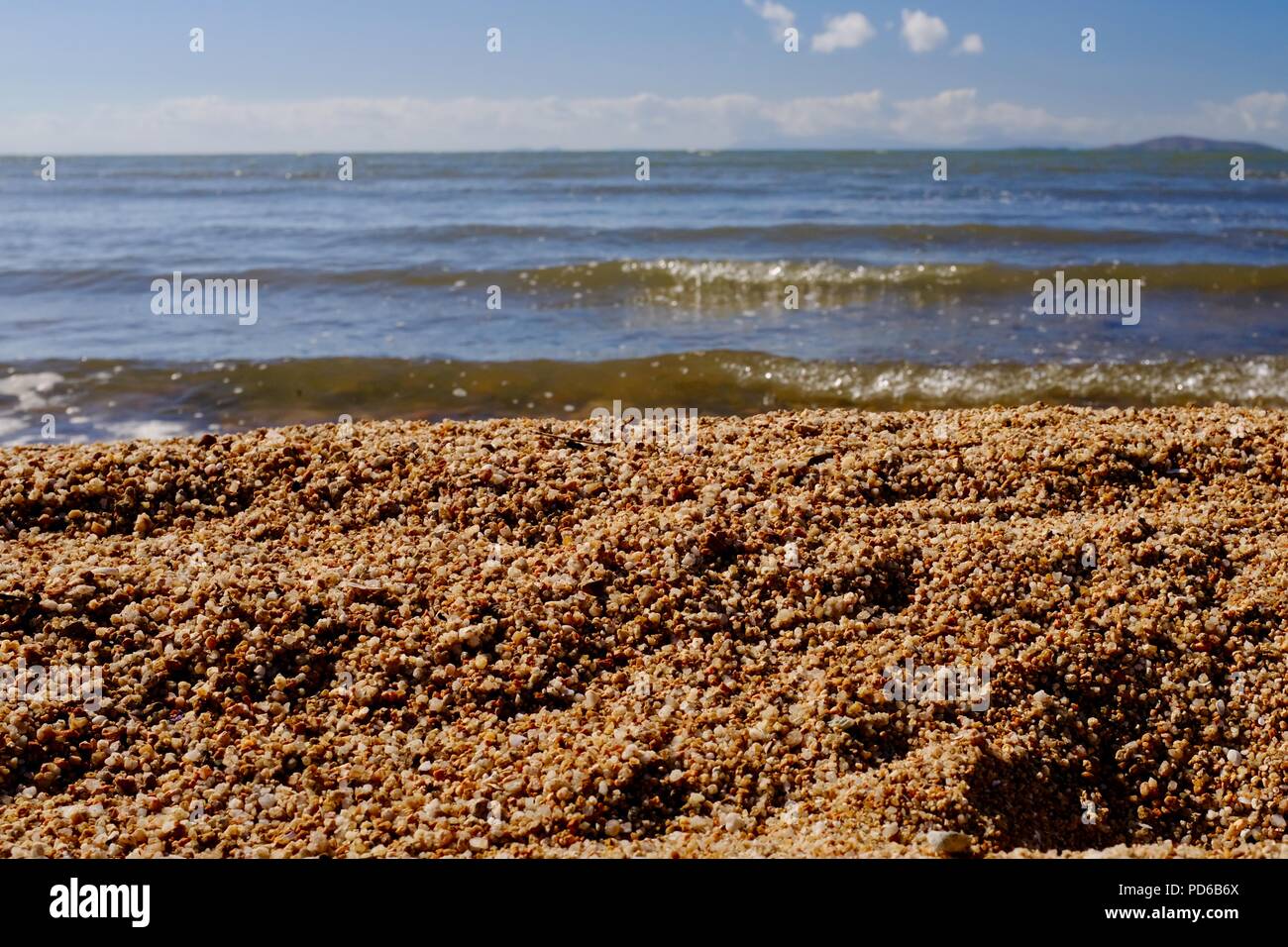 Australian gravel and shell coarse beach sand with waves in the ...