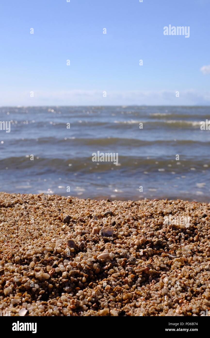 Australian gravel and shell coarse beach sand with waves in the ...