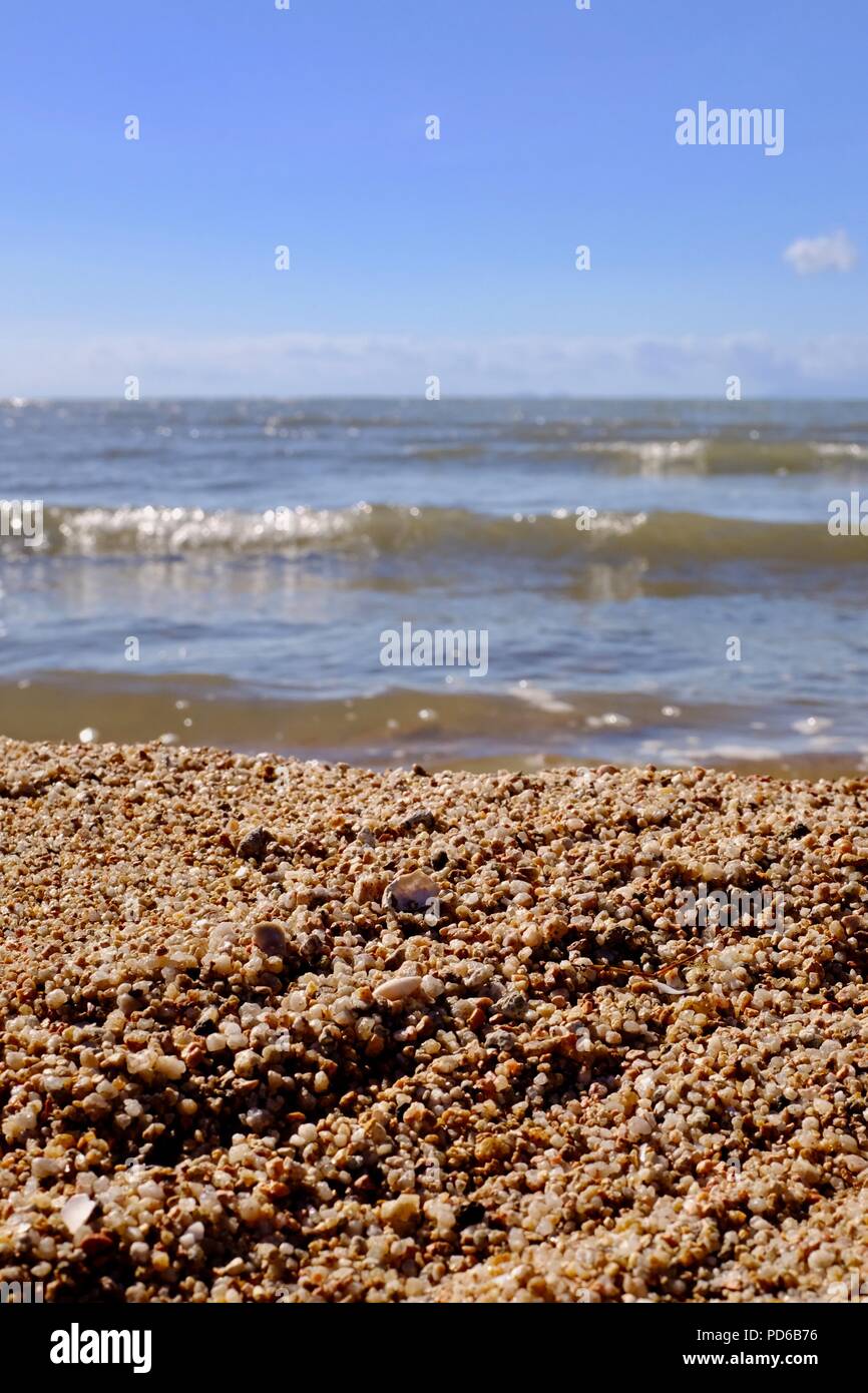 Australian gravel and shell coarse beach sand with waves in the ...