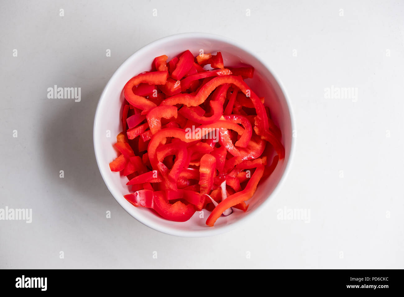top view of sliced red bell pepper on white counter top Stock Photo - Alamy