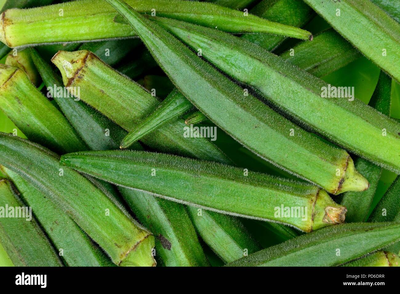Whole raw okra food background Stock Photo - Alamy