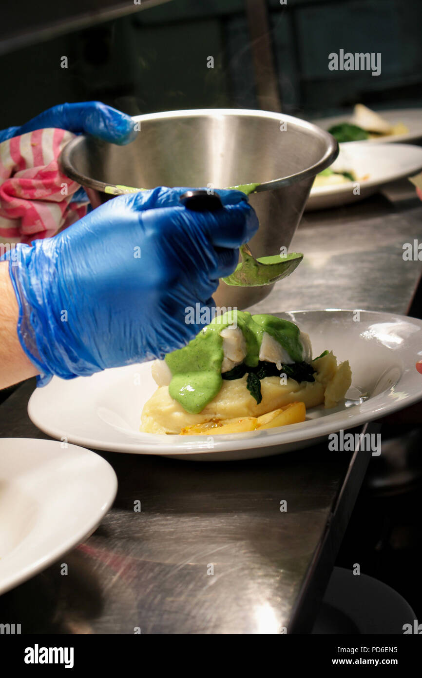 preparing plated food at the kitchen pass Stock Photo - Alamy