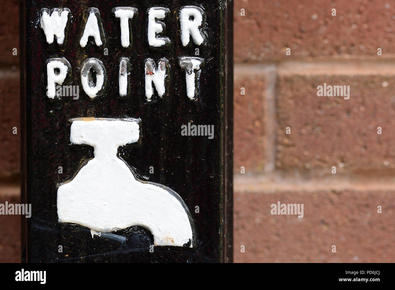 Water Point Sign with white paint text and tap faucet on black ...