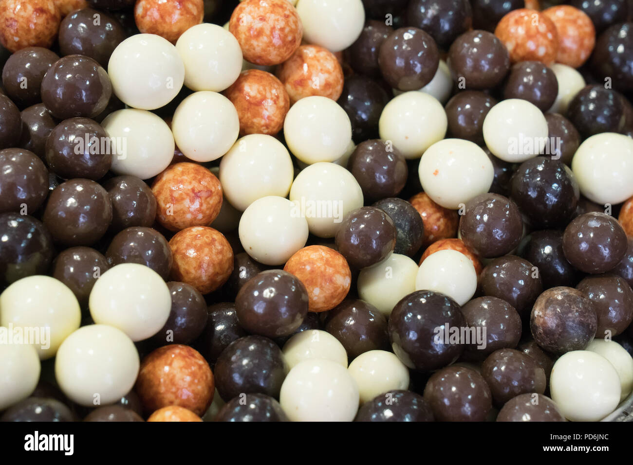 Brown and white chocolate balls in the shop Stock Photo - Alamy