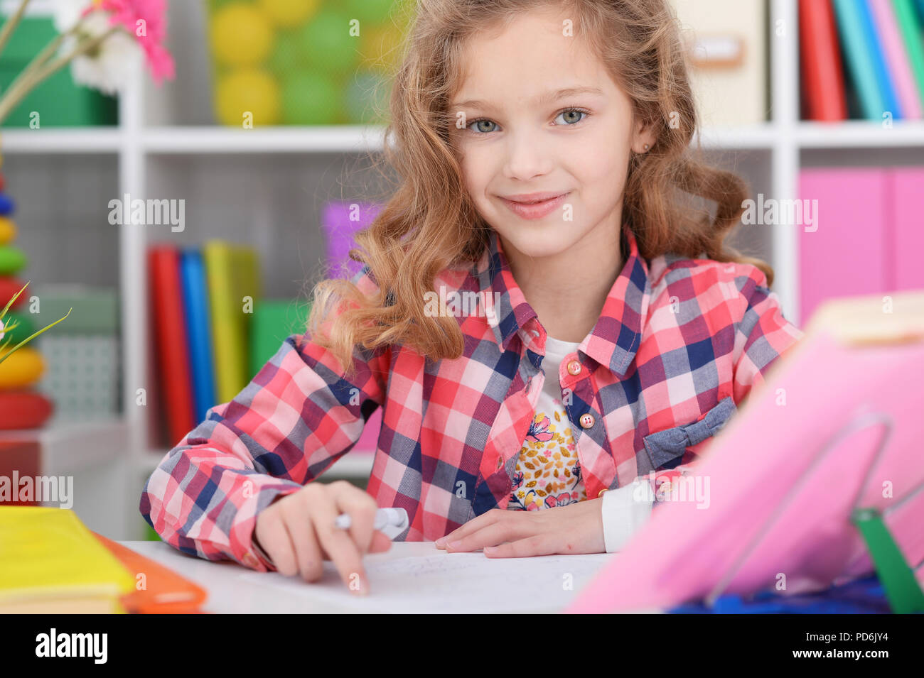 little girl doing homework in her room Stock Photo - Alamy