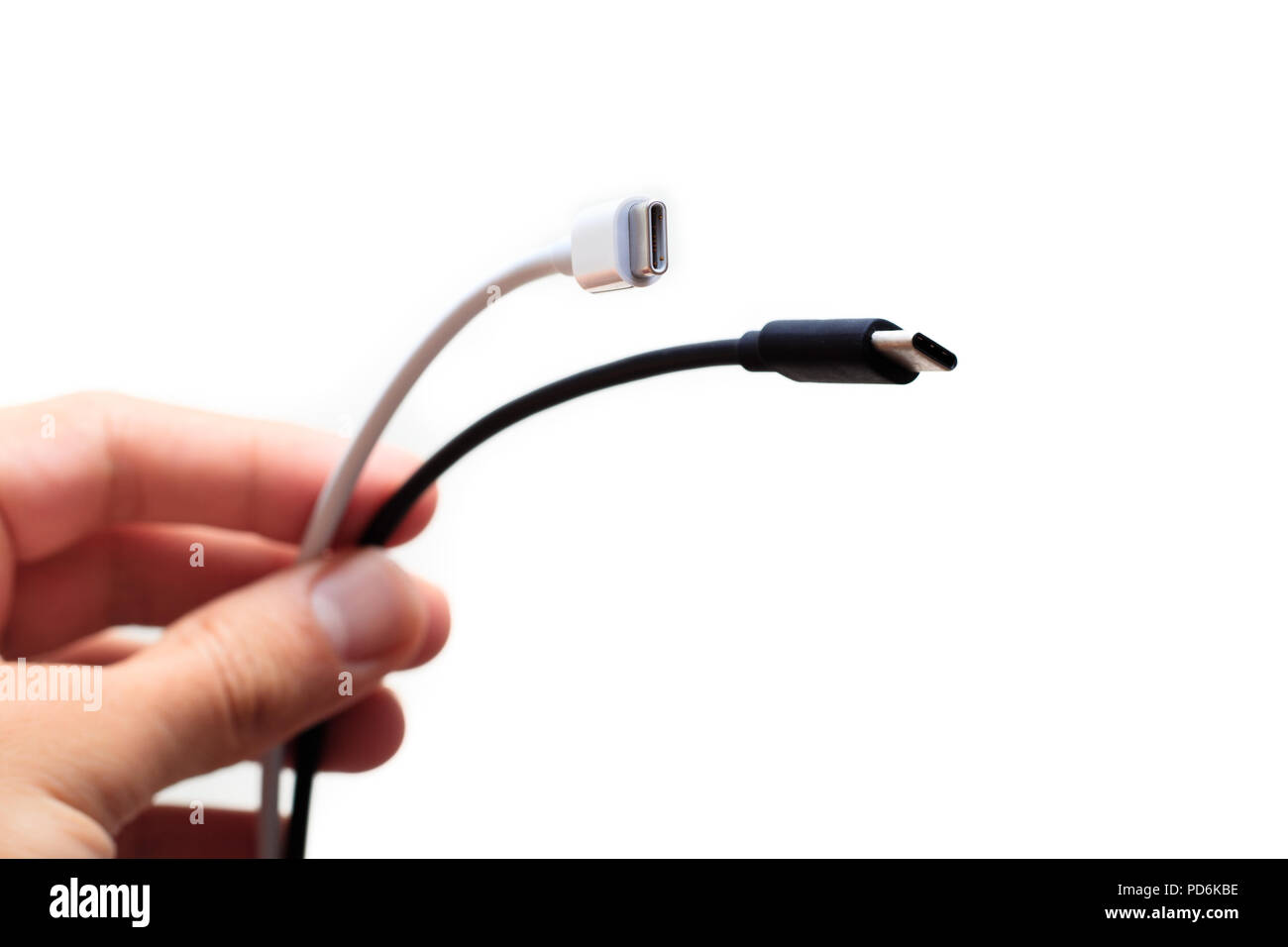 Hand holding black and white Usb type-c connector isolated on white ...