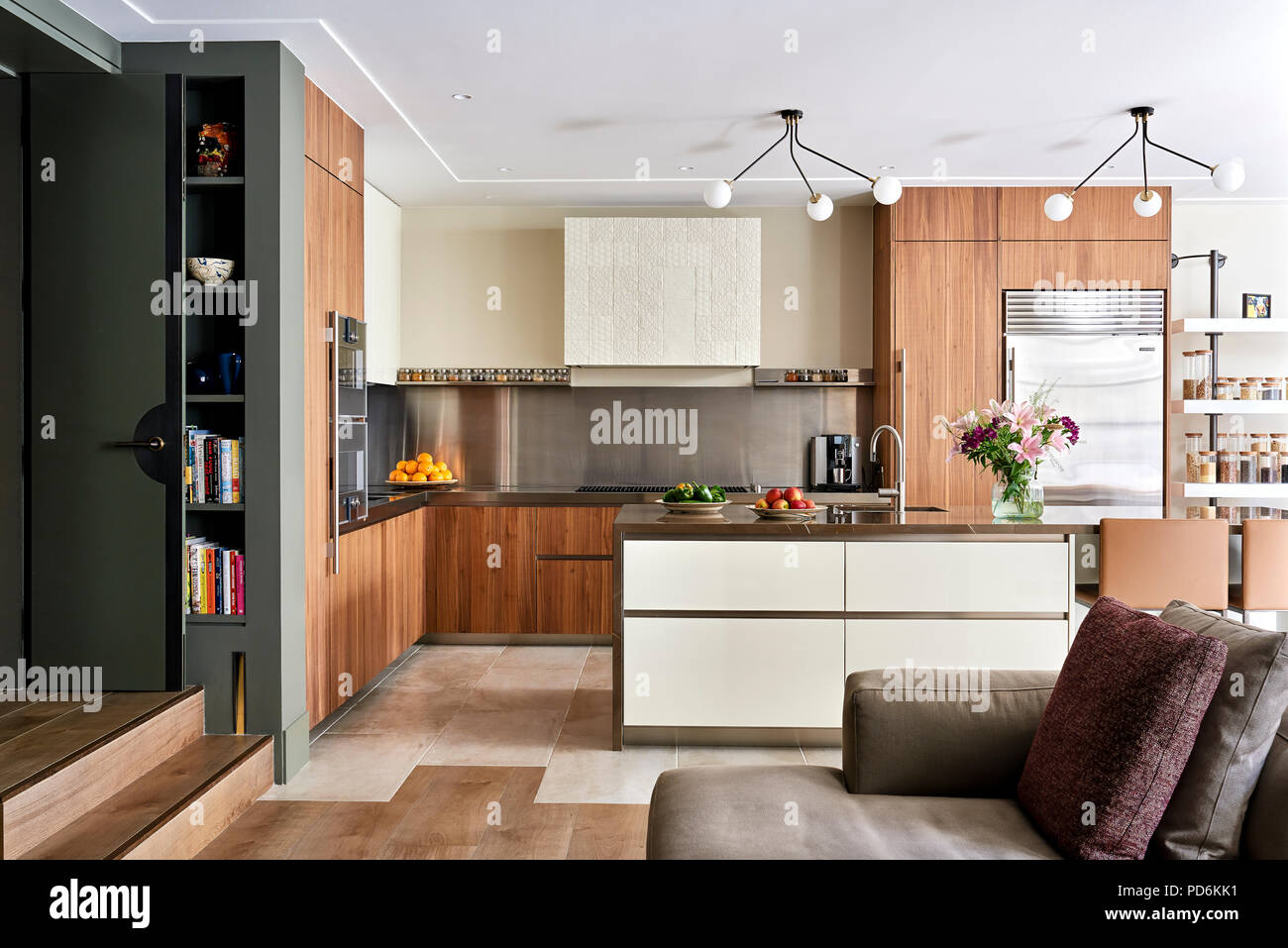 Open plan split level wood and stainless steel kitchen Stock Photo - Alamy