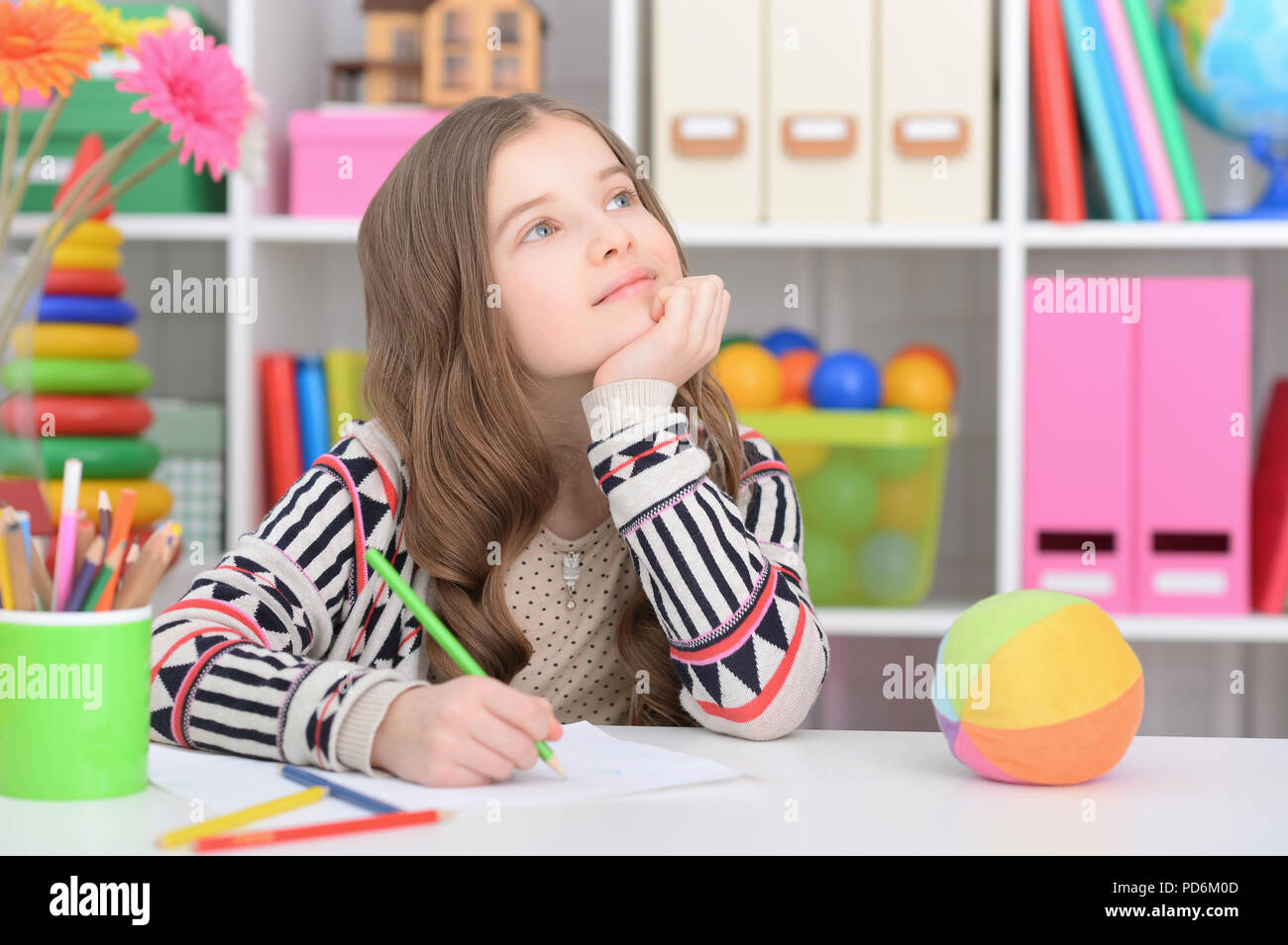 Portrait of cute little girl doing homework Stock Photo - Alamy