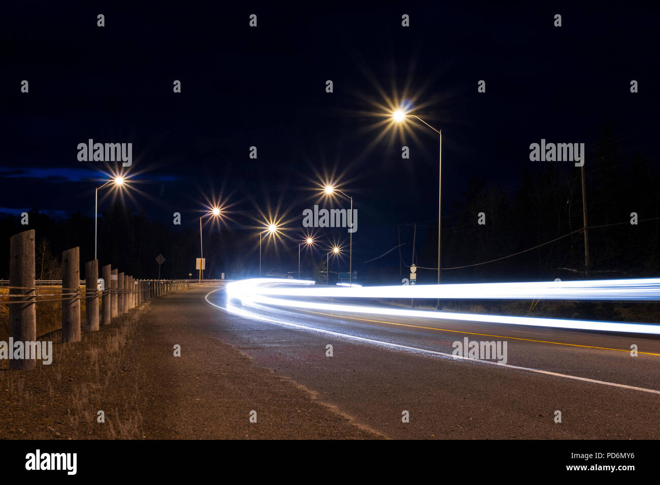 Streetlights light trails from cars and traffic on highway in the late ...