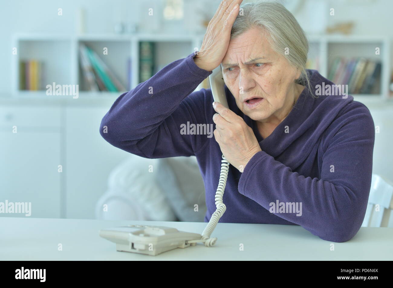 Elderly doctor talking on phone hi-res stock photography and images - Alamy