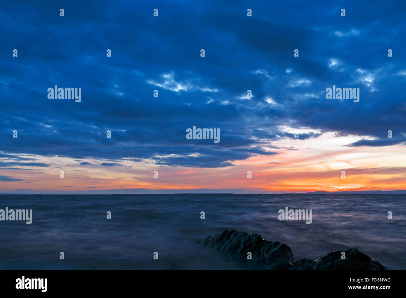 The setting sun lighting up the cloud-cover Stock Photo - Alamy
