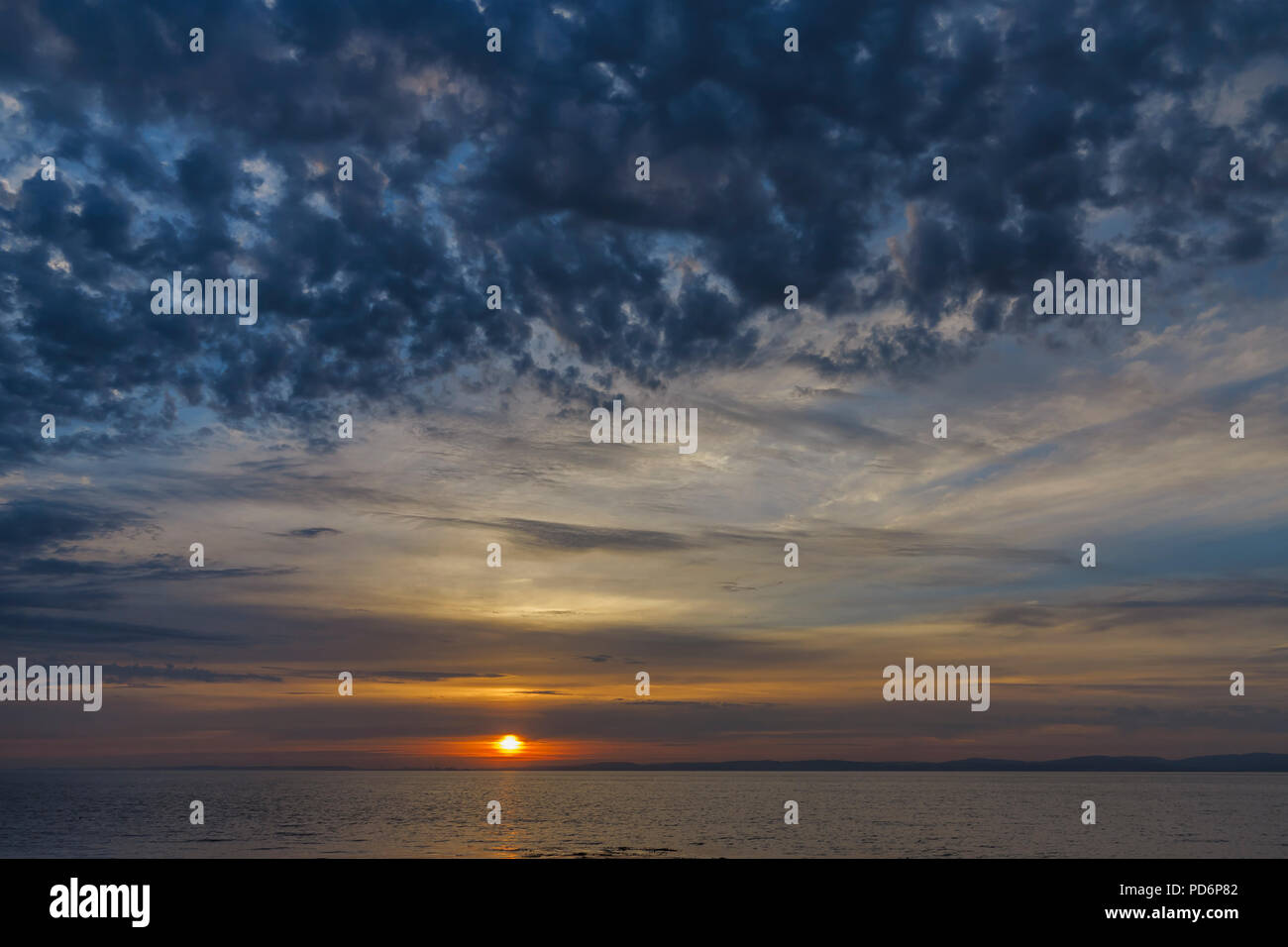 The sun setting Stock Photo - Alamy