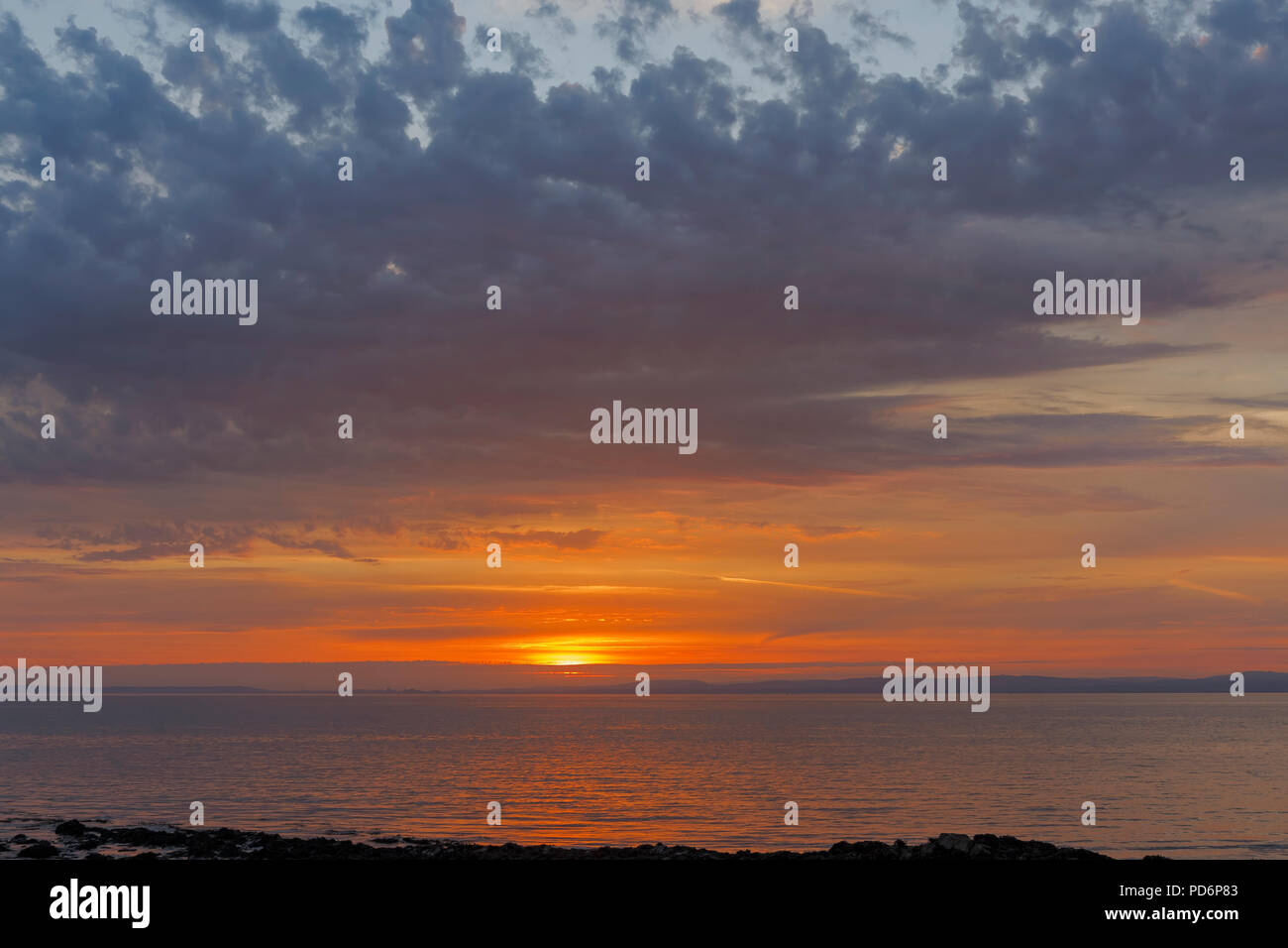 The sun setting Stock Photo - Alamy