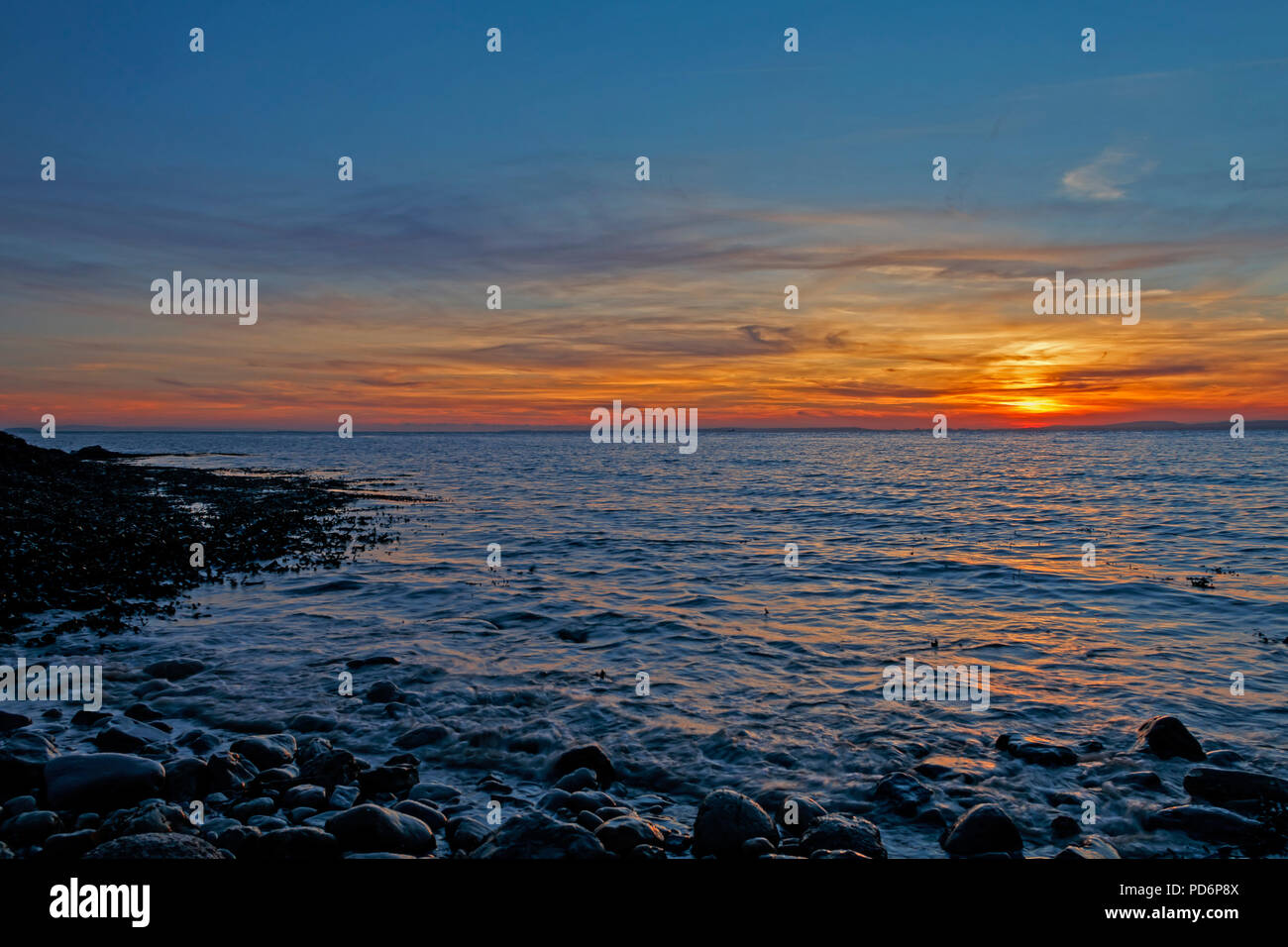 The sun setting Stock Photo - Alamy