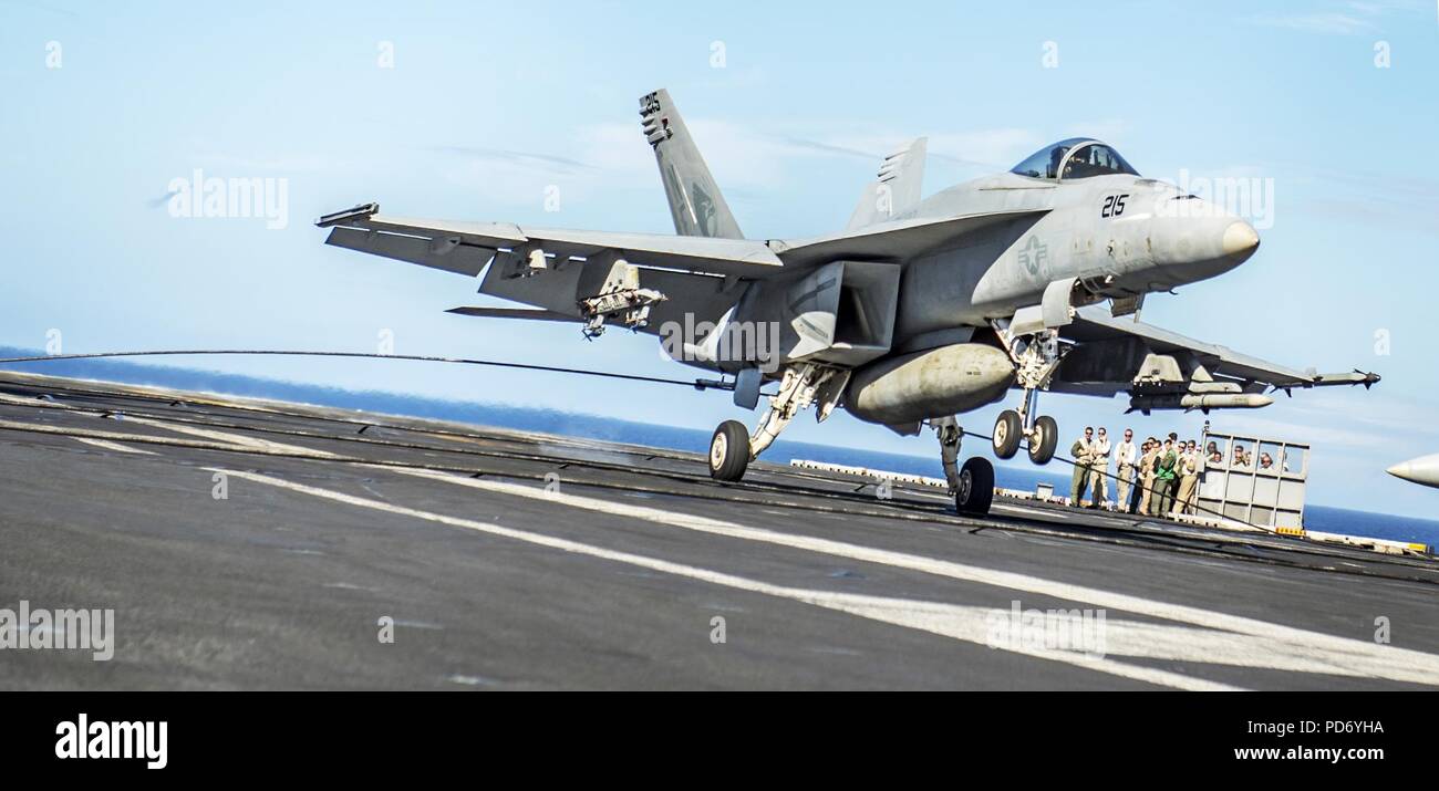 An F A-18E Super Hornet makes an arrested landing on the flight deck ...
