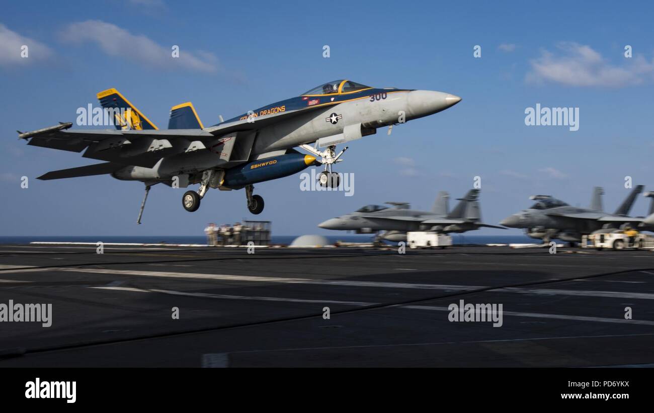 An F-A-18E Super Hornet makes an arrested landing on the flight deck of ...