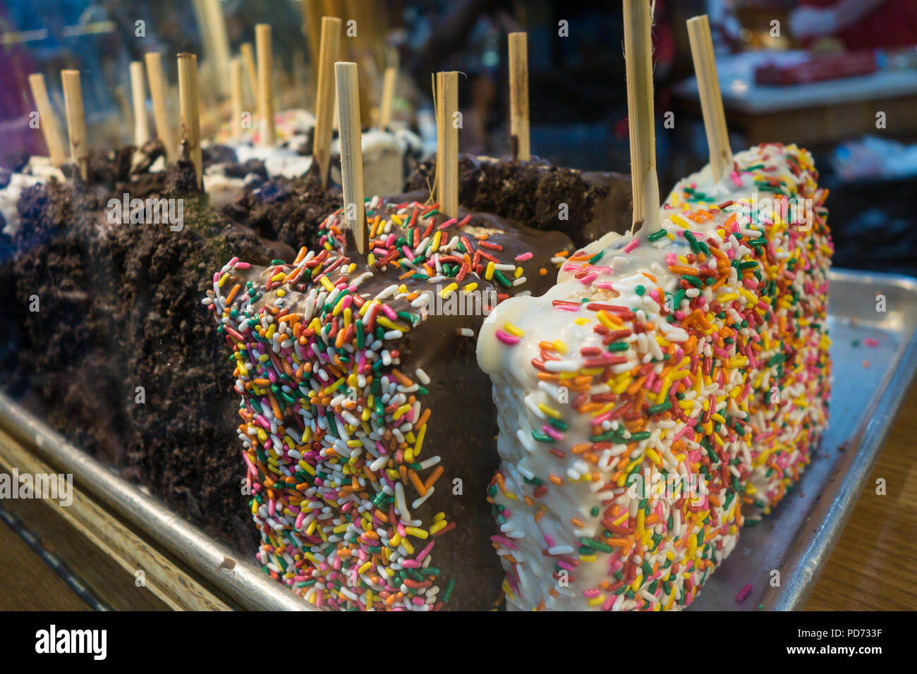 Decadent chocolate covered sweets on display in a shop Stock Photo - Alamy
