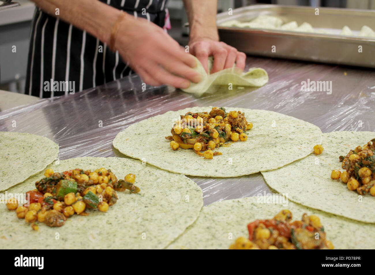 chef preparing chickpea curry wraps Stock Photo - Alamy