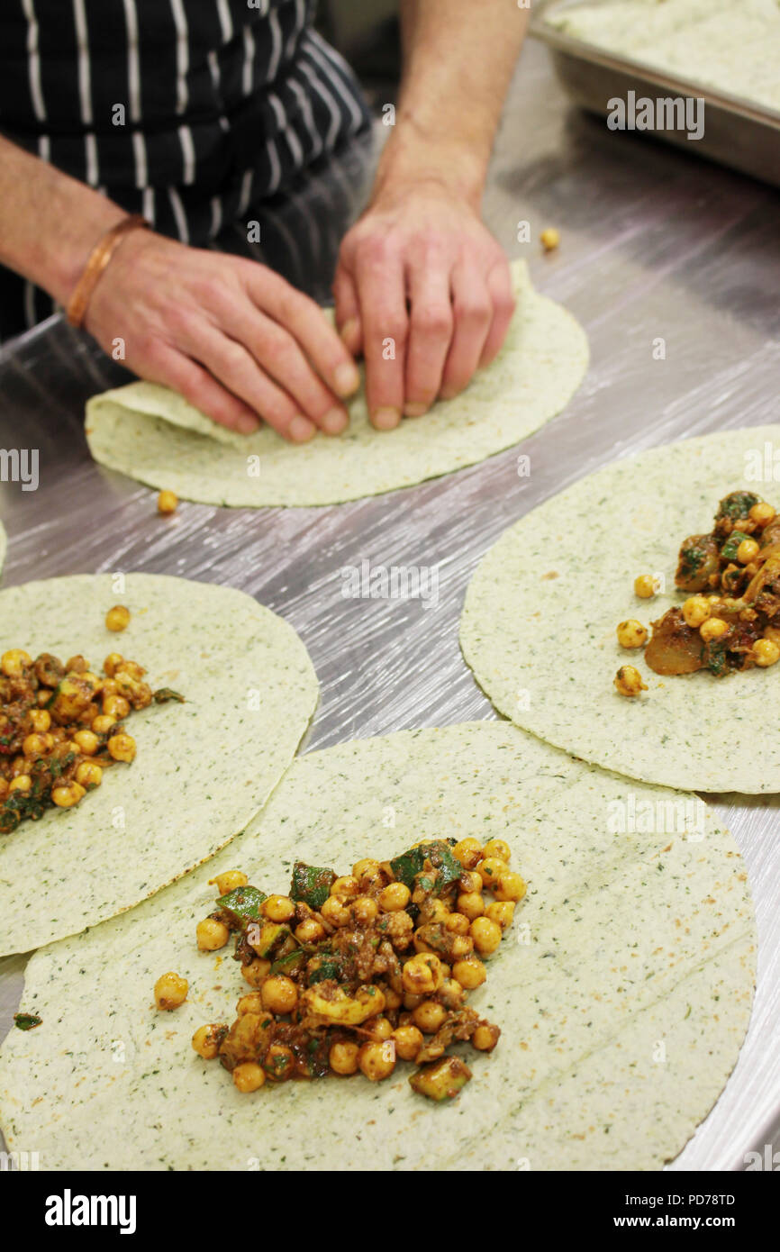 chef preparing chickpea curry wraps Stock Photo - Alamy