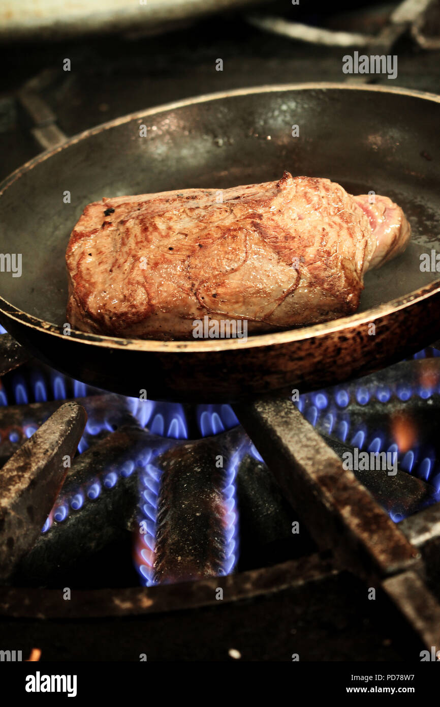 cooking meat on stove Stock Photo - Alamy
