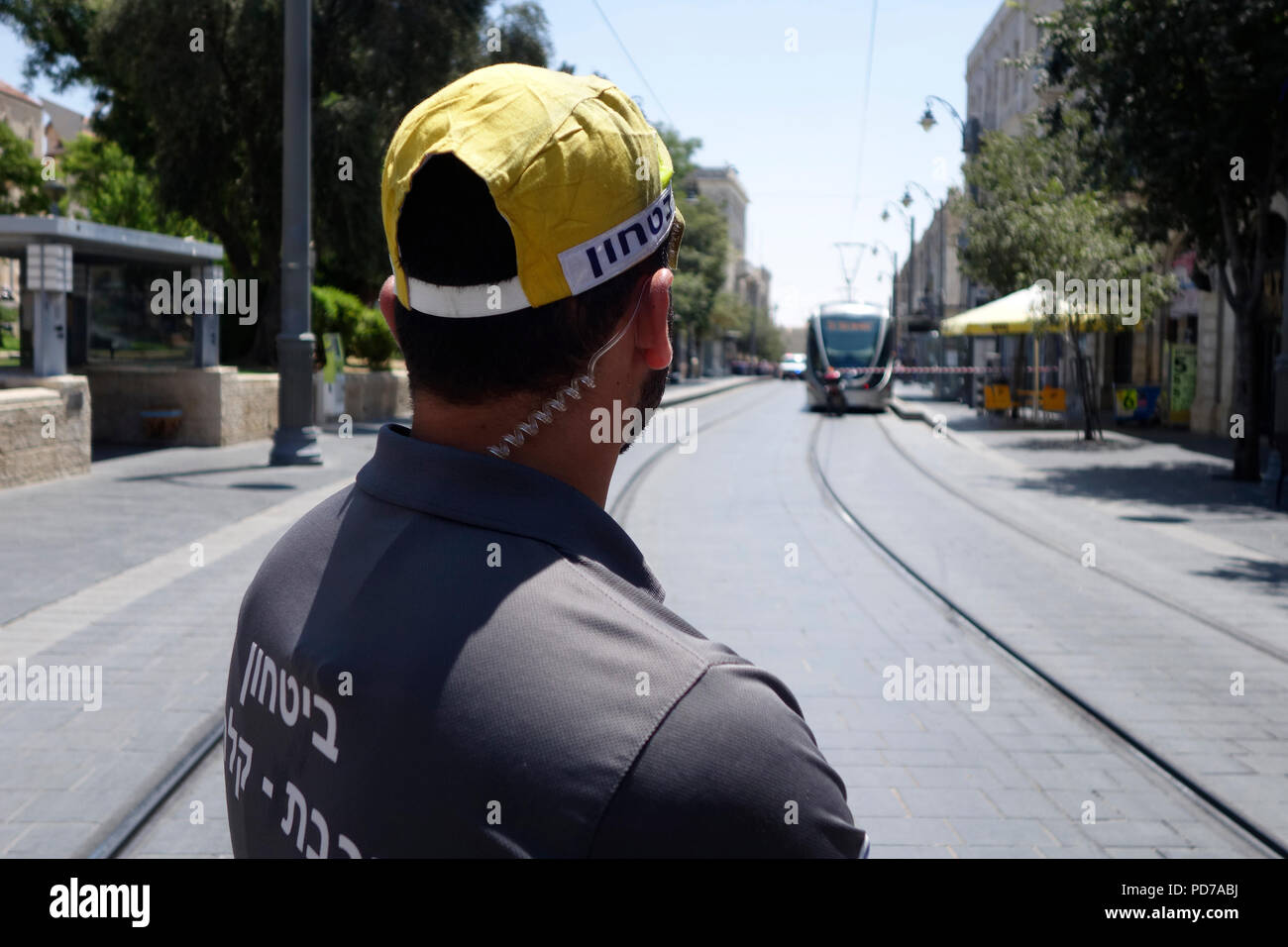 A light rail security guard stands guard as the light rail service ...