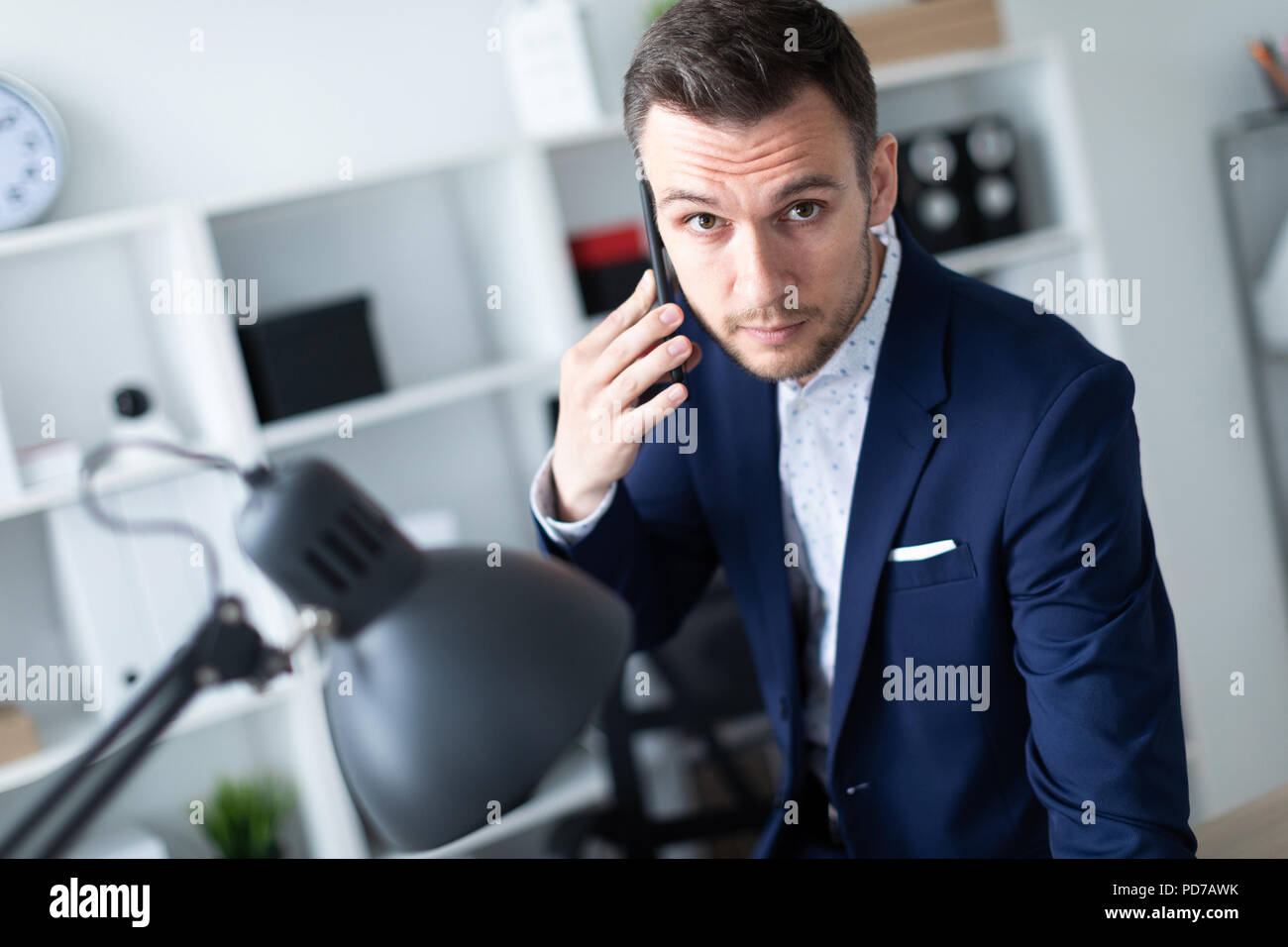 Portrait of a young man talking on the phone Stock Photo - Alamy